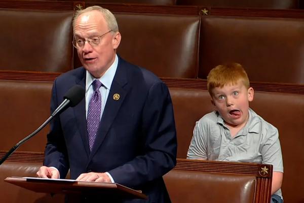 Congressman's son steals the show making silly faces behind dad during ...